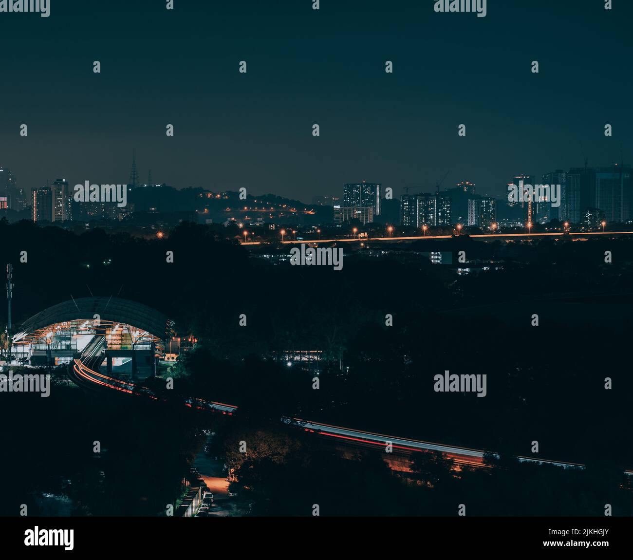 A night view of Bukit Jalil LRT Station with city lights in Kuala ...
