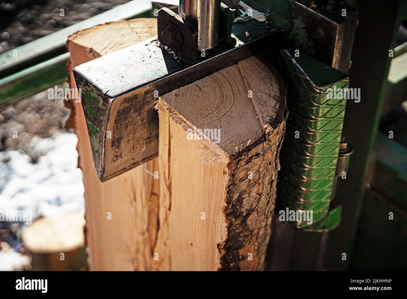 A view of a tree wood being split into two parts by a cutting machine ...
