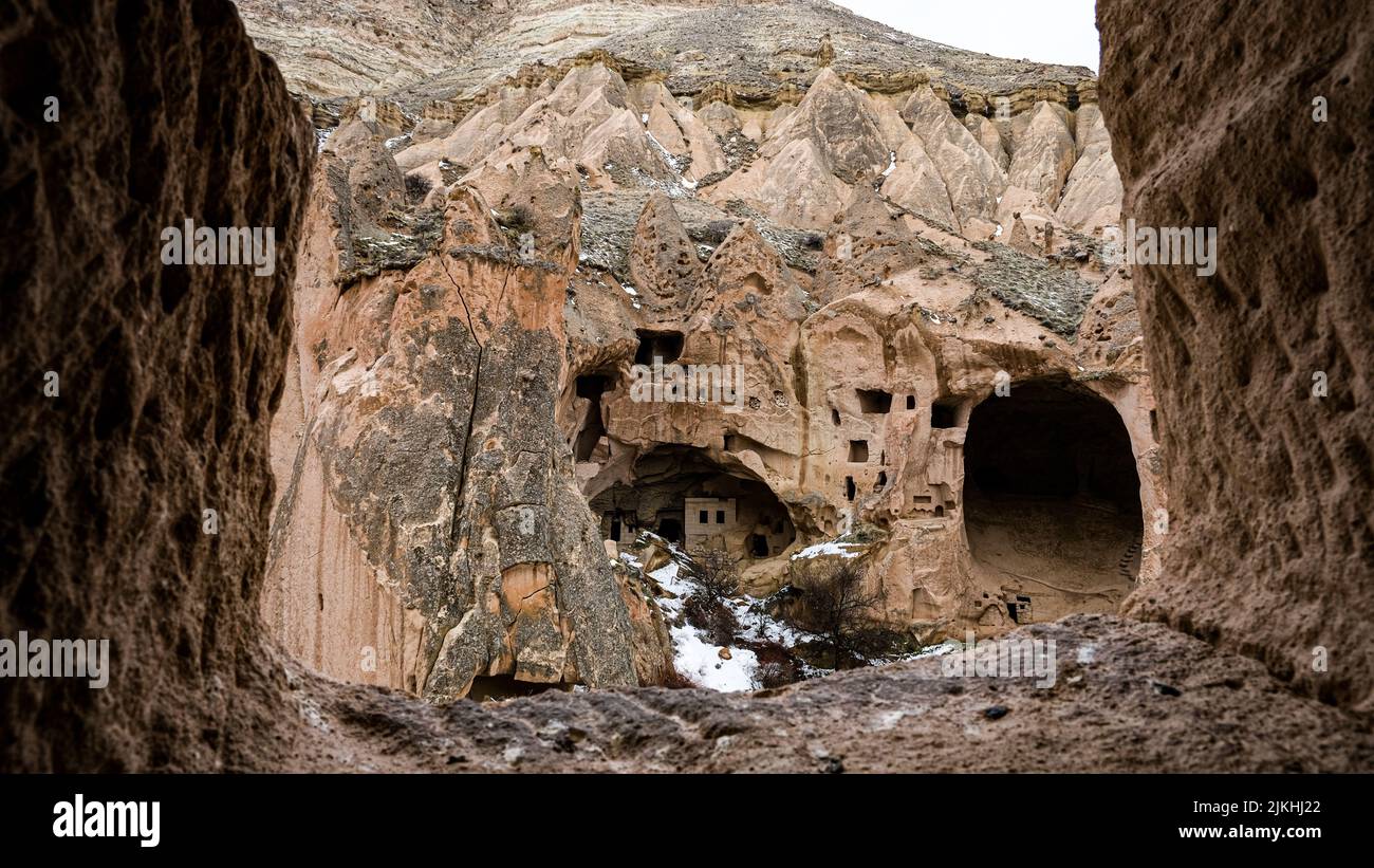 Rocky formations with caves in them in Cappadocia, Turkey Stock Photo ...