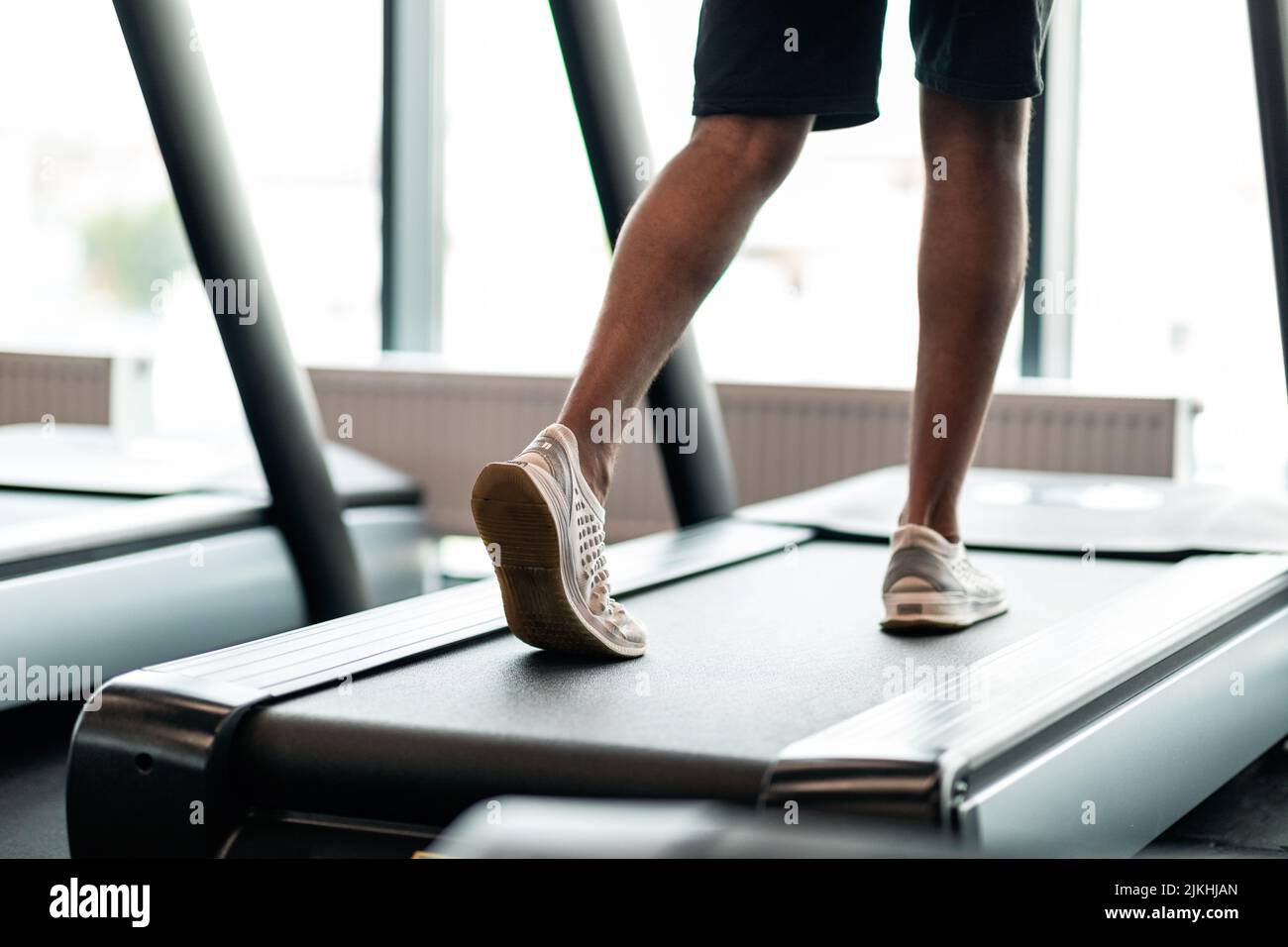 Rear View Of Unrecognizable Black Male Legs Jogging On Treadmill In Gym ...