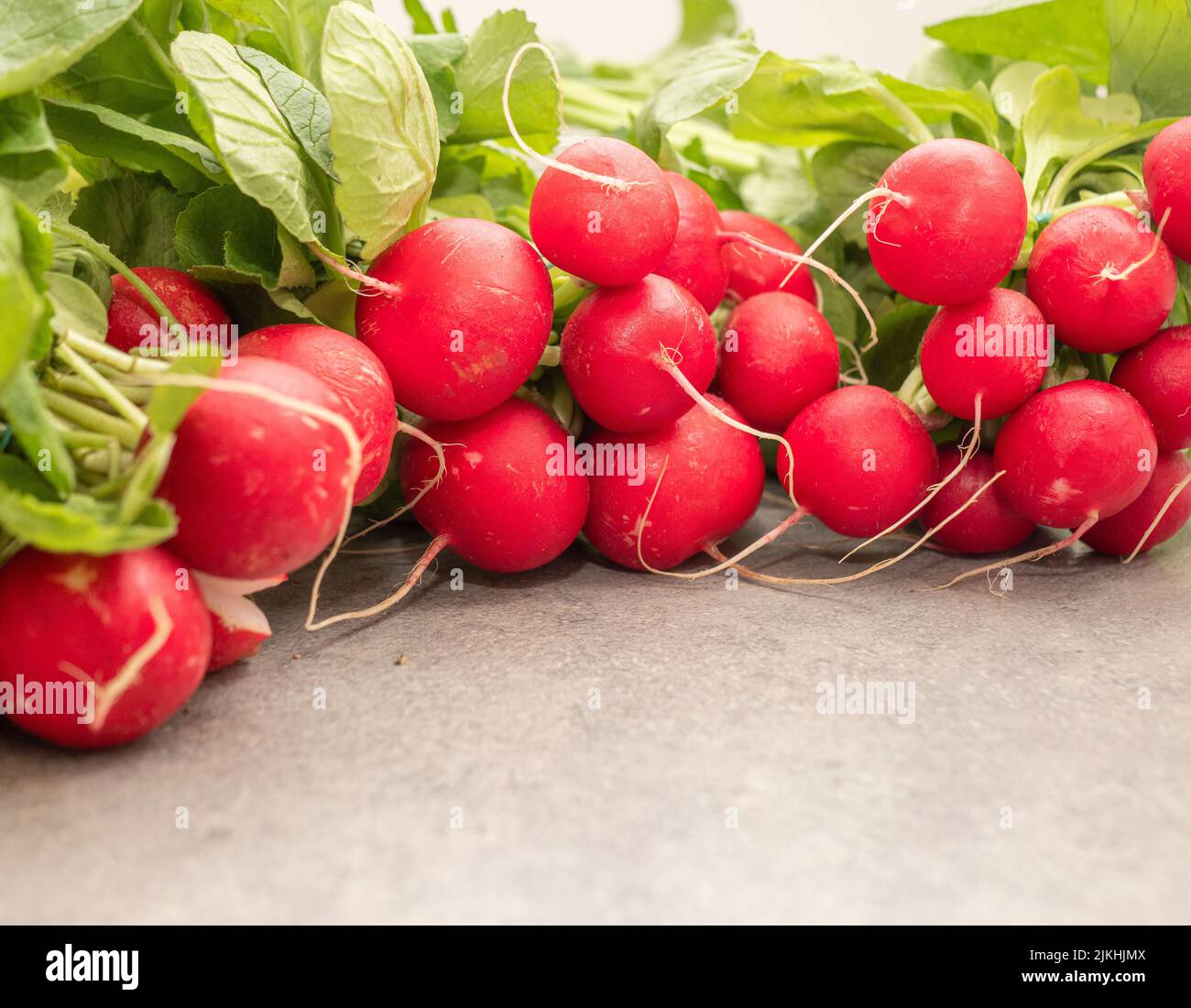 Fresh radishes on old wooden table Stock Photo - Alamy