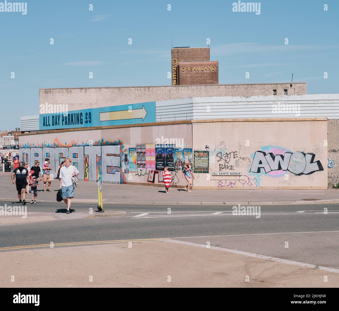 Graffiti posters and tourists in the urban seaside landscape of Margate ...