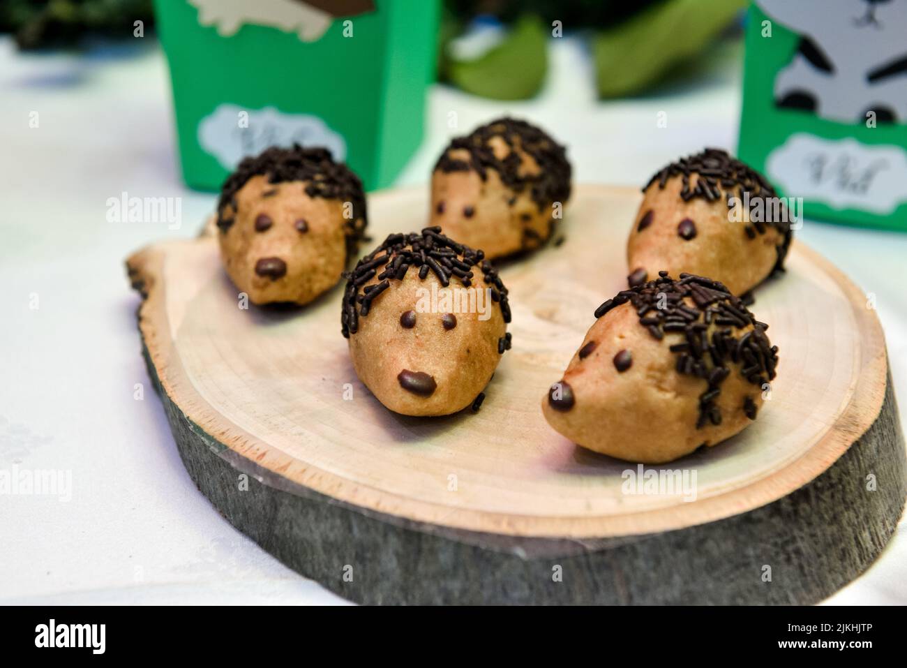 The hedgehog creme puffs on a wooden plate on the table Stock Photo - Alamy