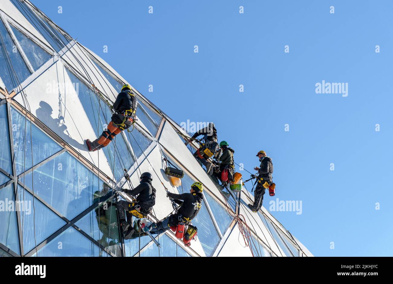 The professional window cleaners on a modern building with a glass ...