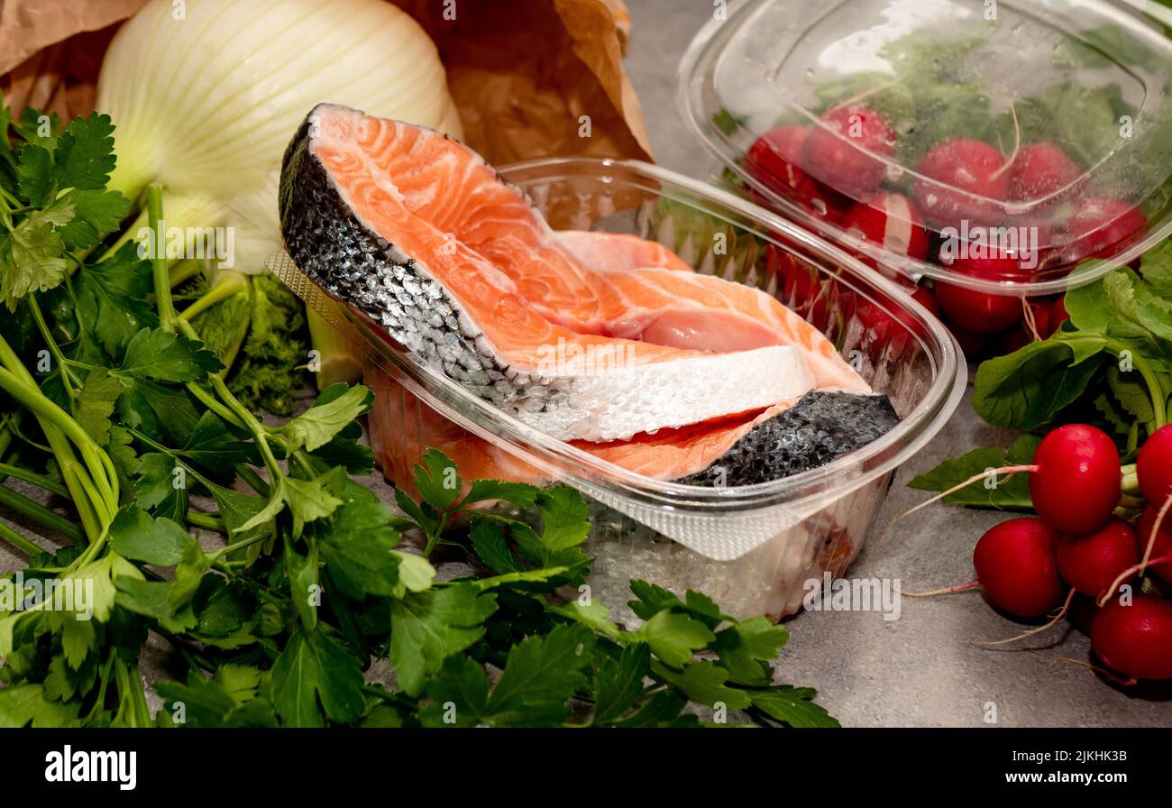 Fried salmon steaks with vegetables on wooden table Stock Photo - Alamy