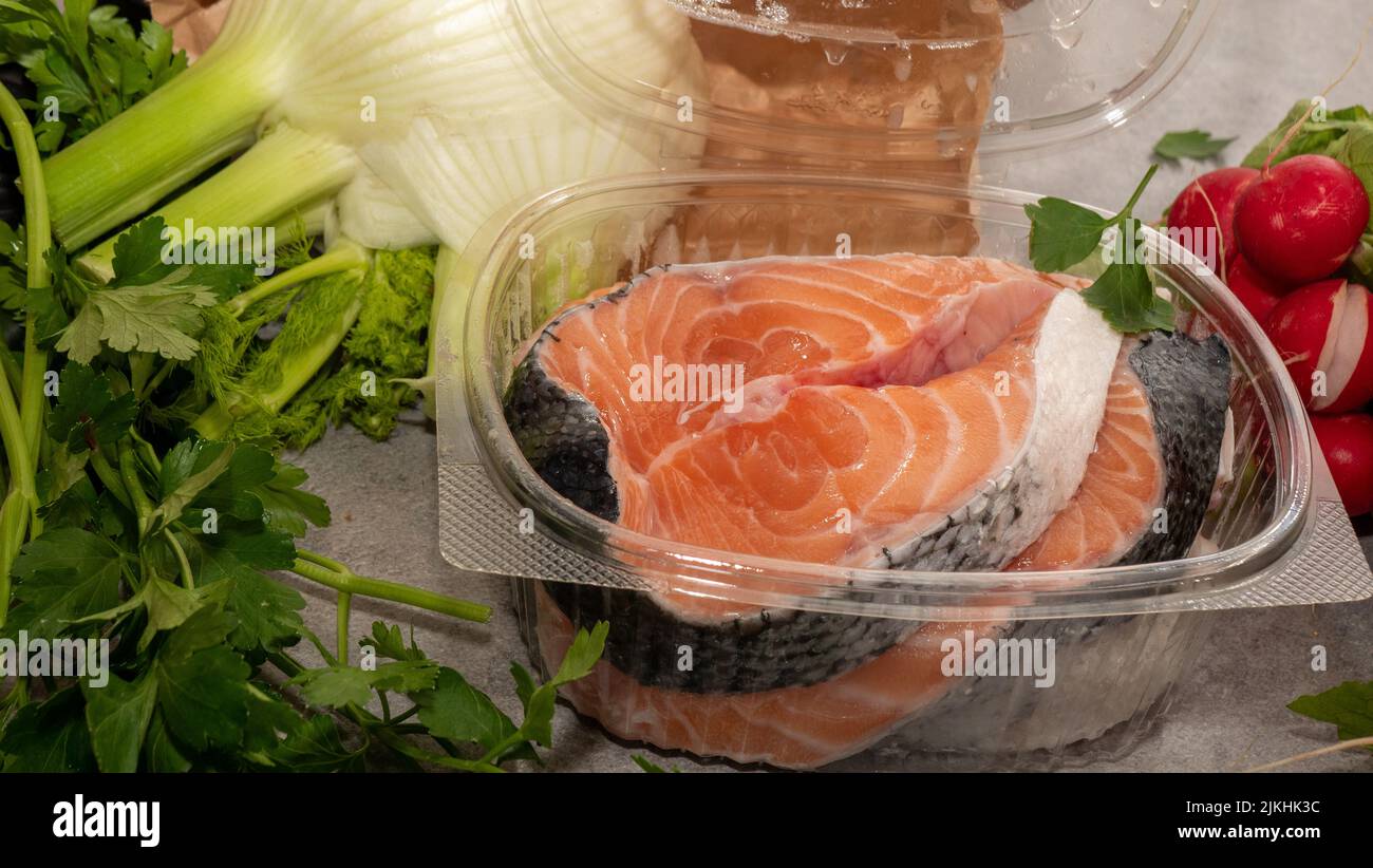 Fried salmon steaks with vegetables on wooden table Stock Photo - Alamy