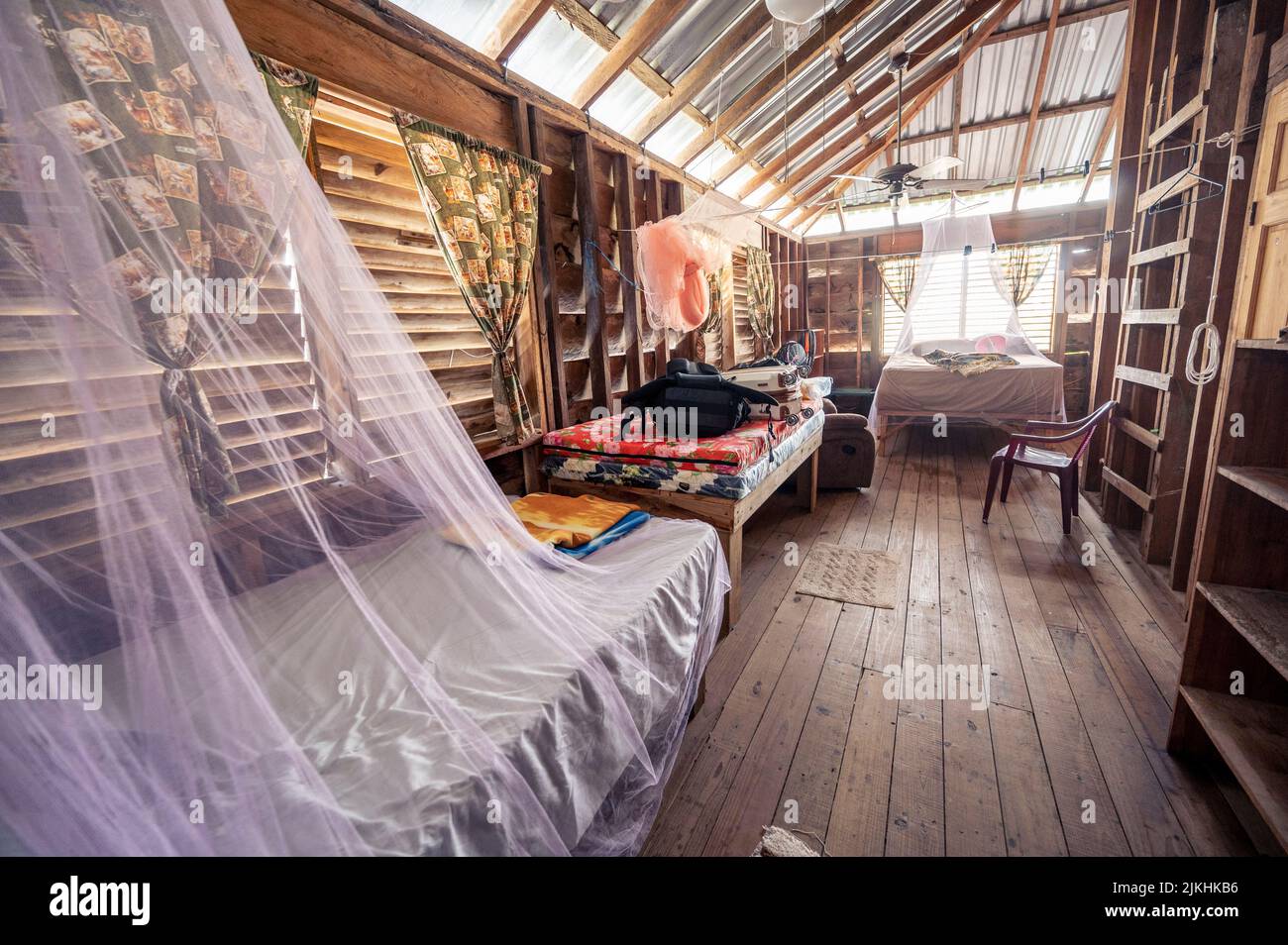 An inside view of a wooden house with multiple beds Stock Photo - Alamy