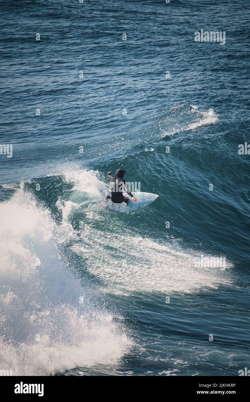 A vertical shot of a man surfing on a wave in Pichilemu, Chile Stock ...