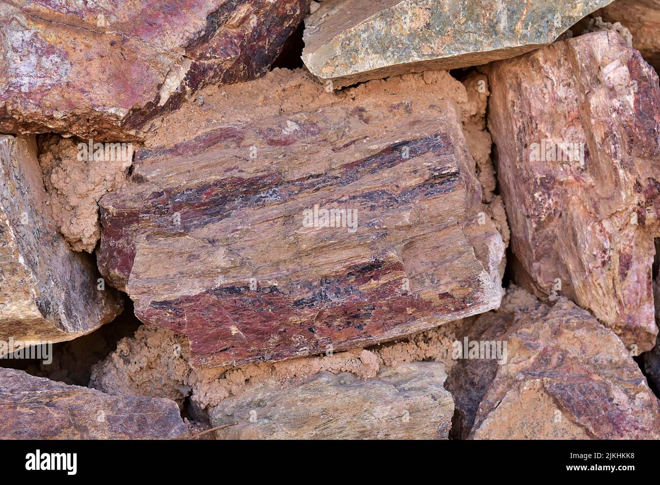 A wall made up of large red boulders Stock Photo - Alamy