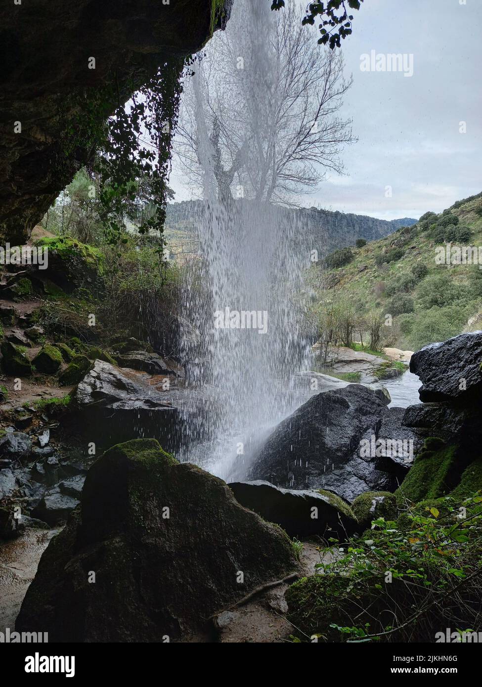 A view of the waterfall from a cave Stock Photo - Alamy