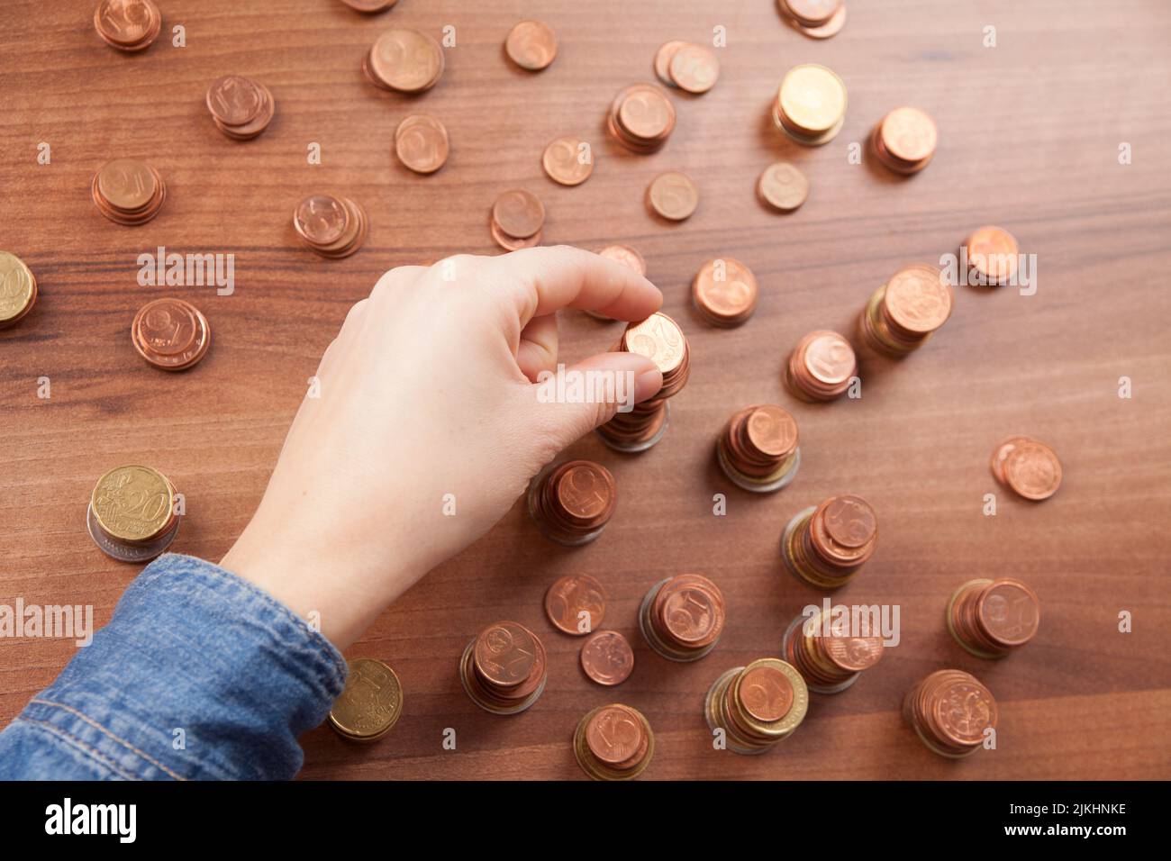 A top view of a human counting his stacks of coins savings Stock Photo ...