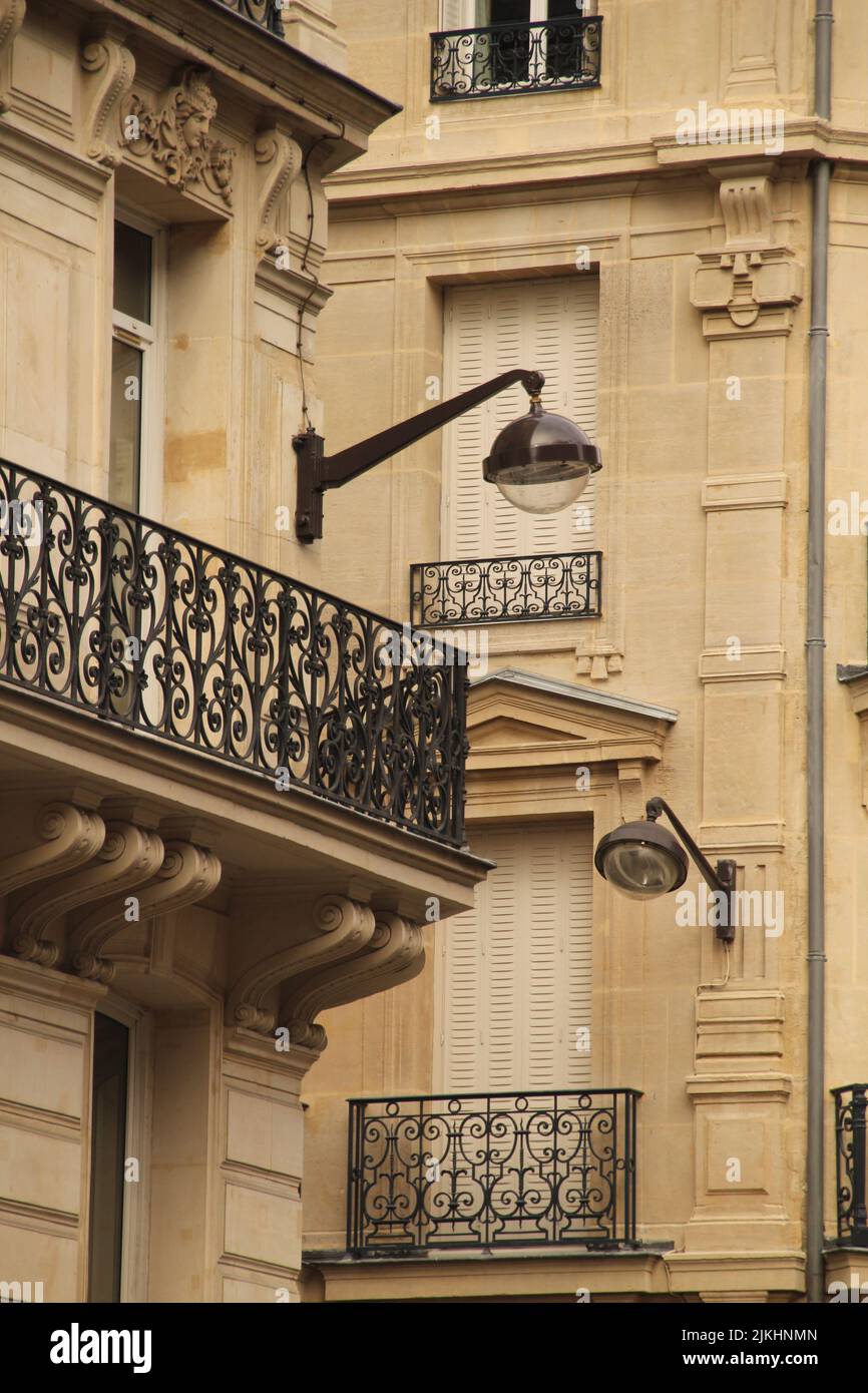 A vertical closeup shot of the French style building facade with ...