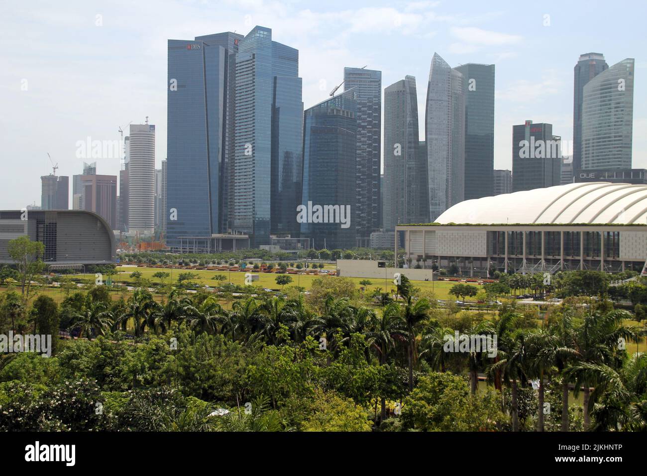 Modern skyscrapers with green tropical vegetation in the foreground in ...