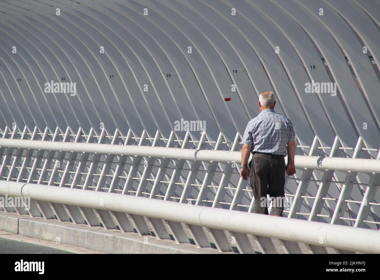 An aging man crossing a modern bridge in Bilbao, Spain Stock Photo - Alamy