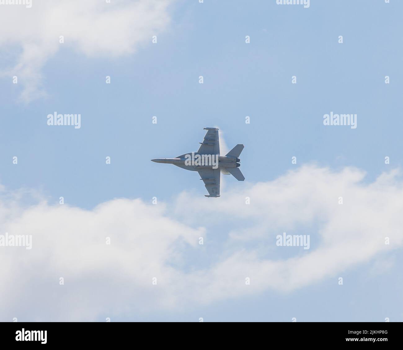 A beautiful view of a F18 Fighter Jet in a sky with clouds Stock Photo ...