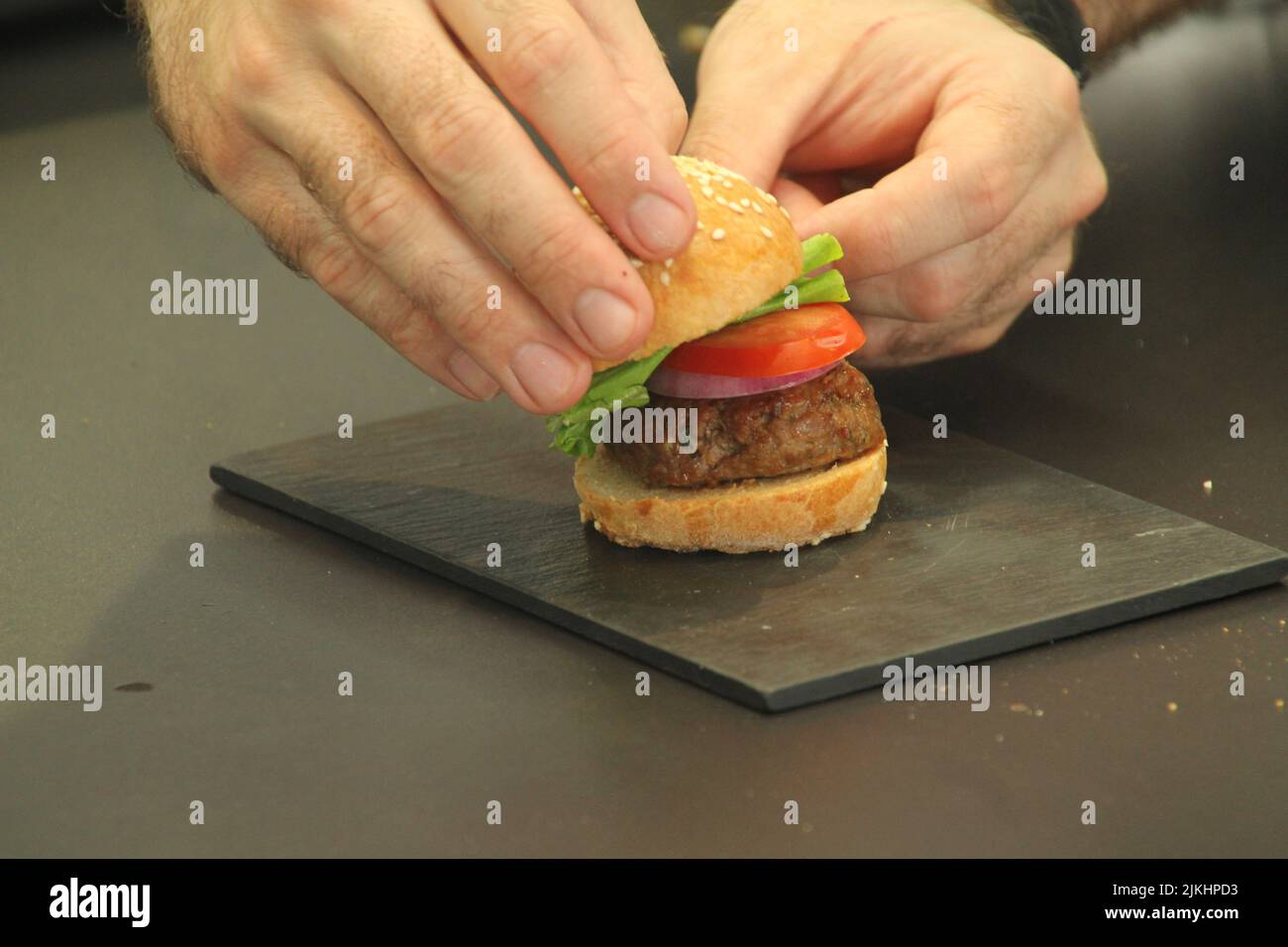 Making cheeseburger on plate hi-res stock photography and images - Alamy