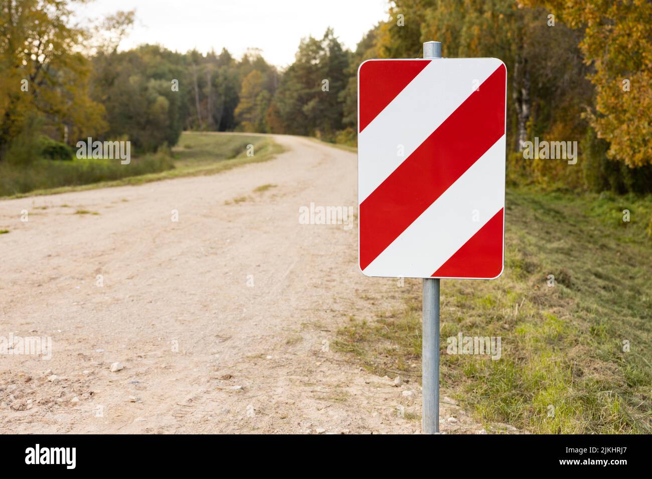 A red line road sign on a gravel road Stock Photo - Alamy