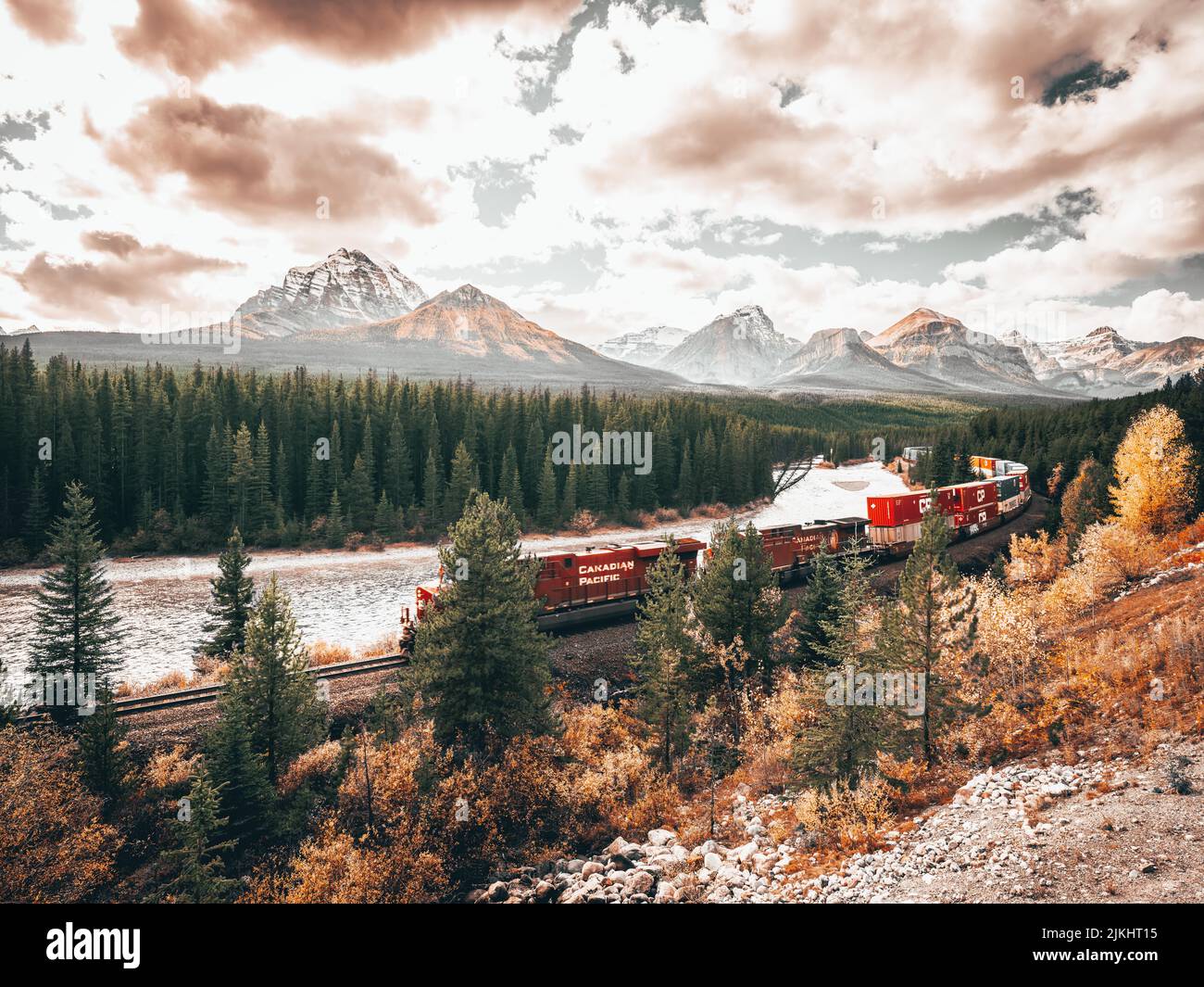 The setting Sun over a Canadian Pacific train as it rounds Morant's Curve near Lake Louise ...
