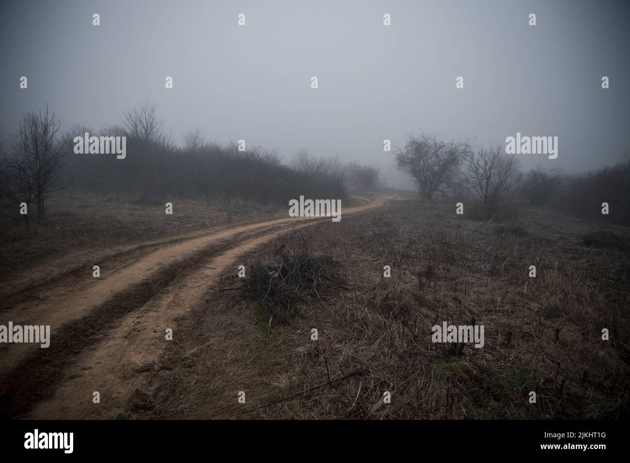 A rural trail through dry foggy hills Stock Photo - Alamy