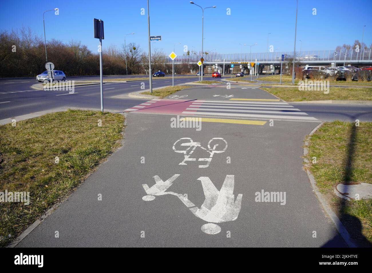 a Path with bicycle and pedestrian symbol leading to zebra crossing in ...