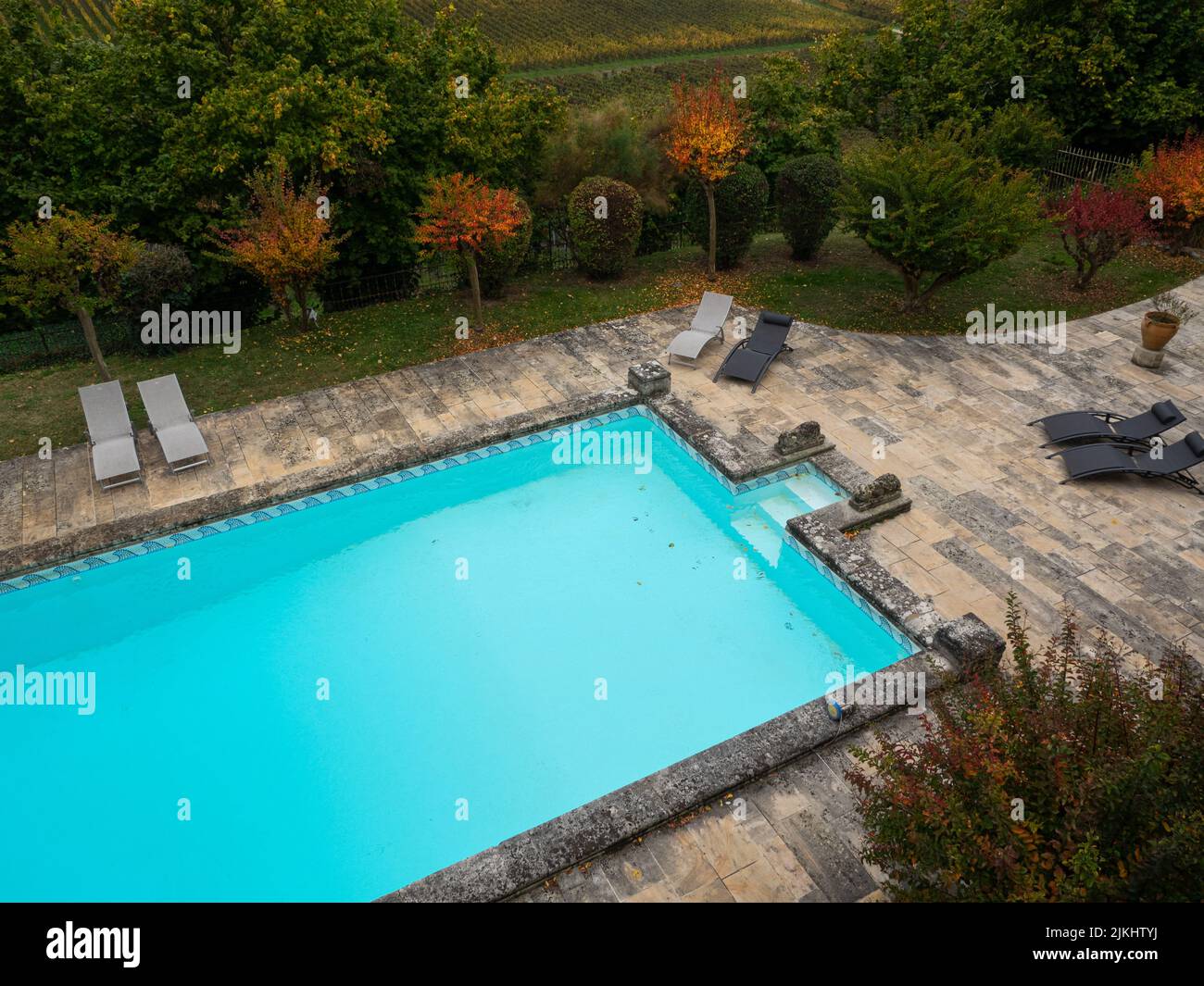 Top view of a classic swimming pool with sun loungers in a garden Stock ...