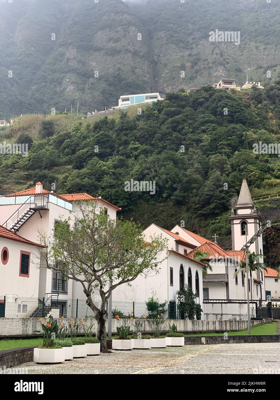 A vertical shot of a white castle in a small village of Maderia Island ...