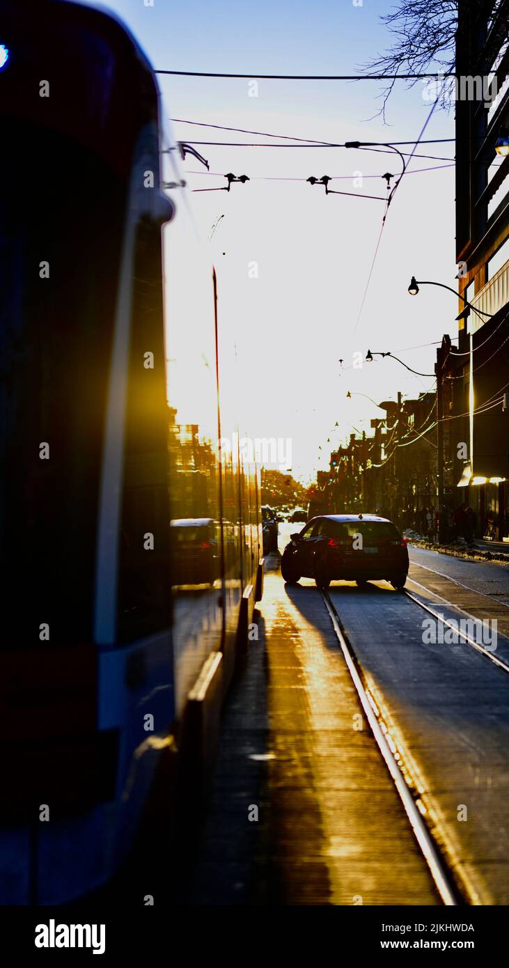 A vertical shot of a car on the street during sunset in Toronto Stock ...