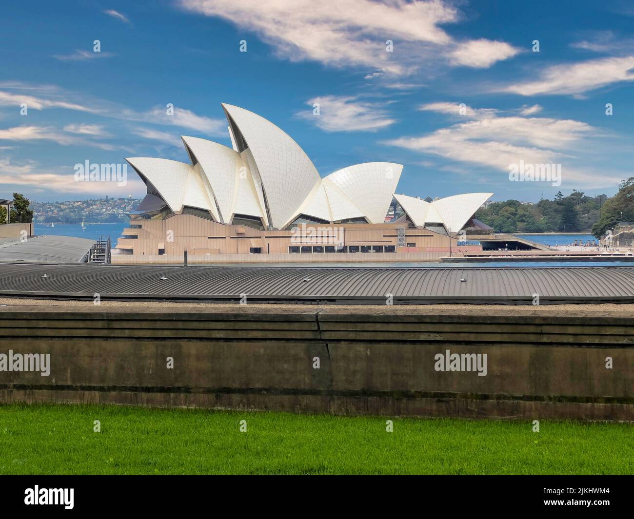 Seeing Sydney Opera House from a far green grassland point under the ...