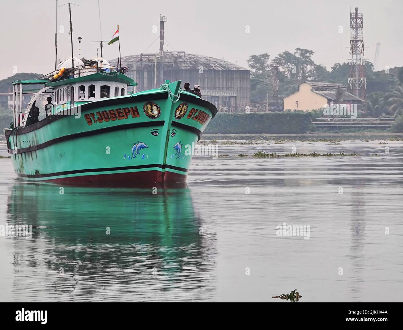 A green beautiful shot of a fishing boat in the seawater of Kochi ...