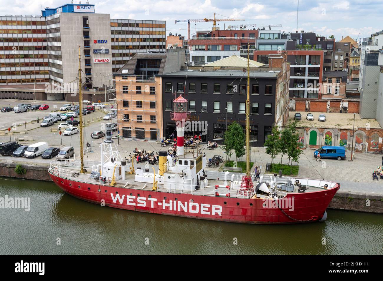 A red ship docked in the harbor of Antwerp on the Scheldt river ...
