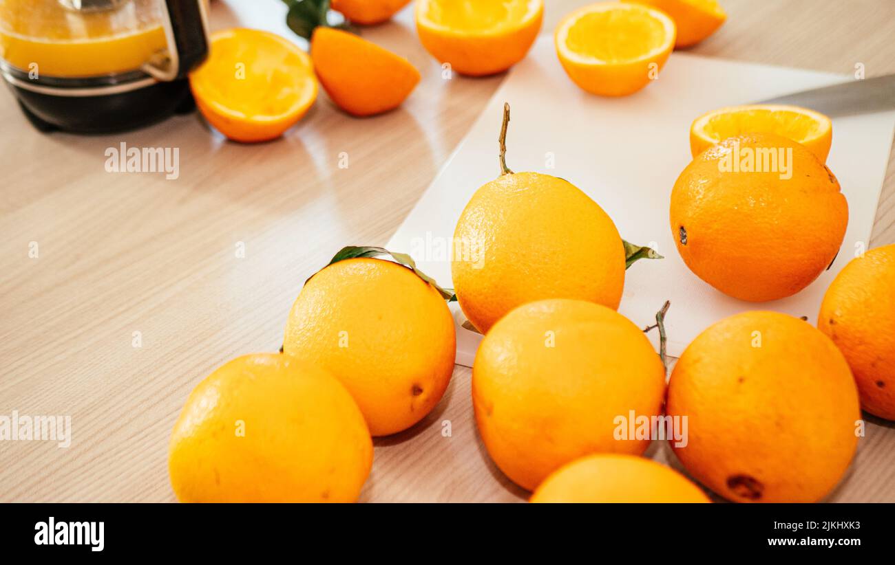 Squeezed orange juice and fresh oranges fruits on wooden table Stock ...