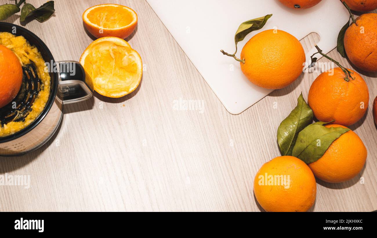 Squeezed orange juice and fresh oranges fruits on wooden table Stock ...