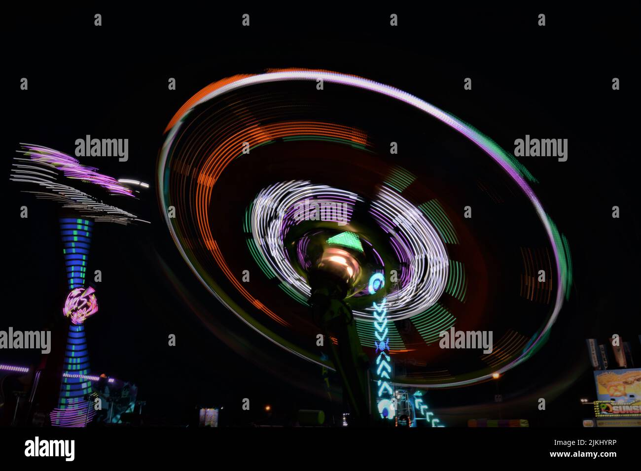 A collection of rides at a county fair taken at night time Stock Photo ...