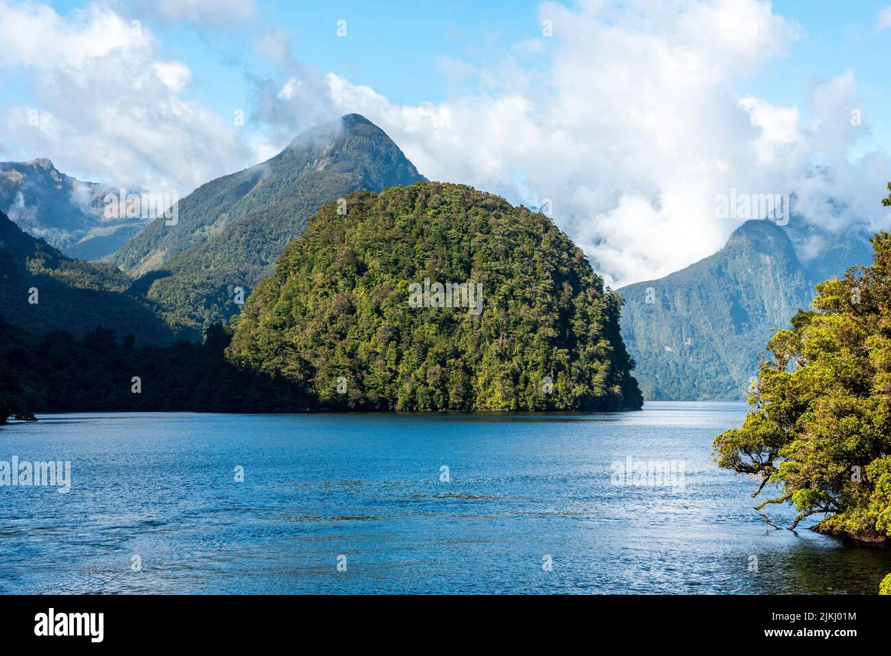 A new morning dawning at Doutful Sound, clouds hanging low in the ...