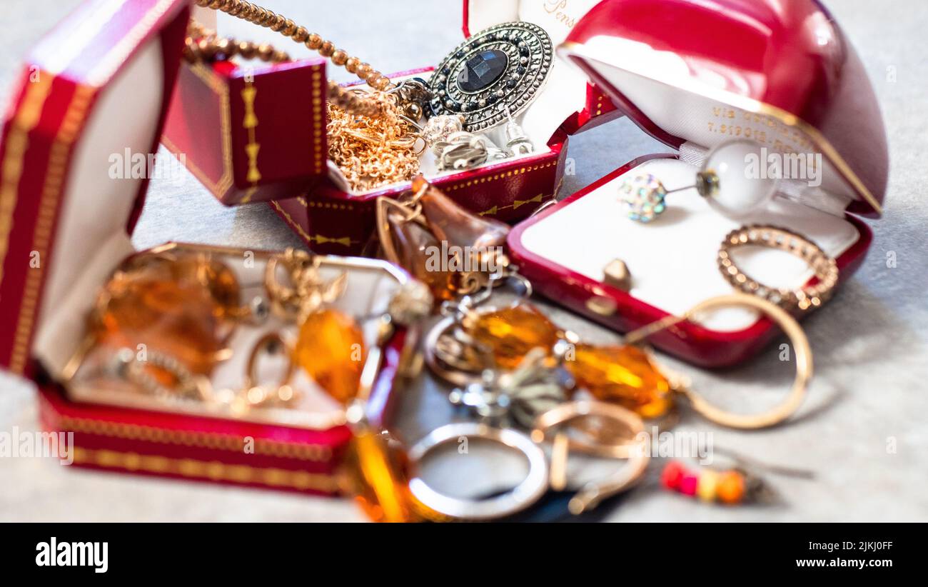 Old red boxes full of jewelry. Treasure chest, close up Stock Photo - Alamy