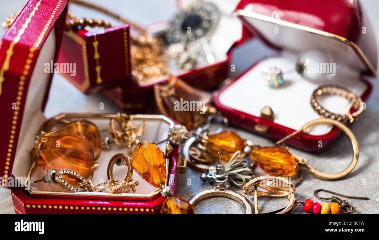 Old red boxes full of jewelry. Treasure chest, close up Stock Photo - Alamy