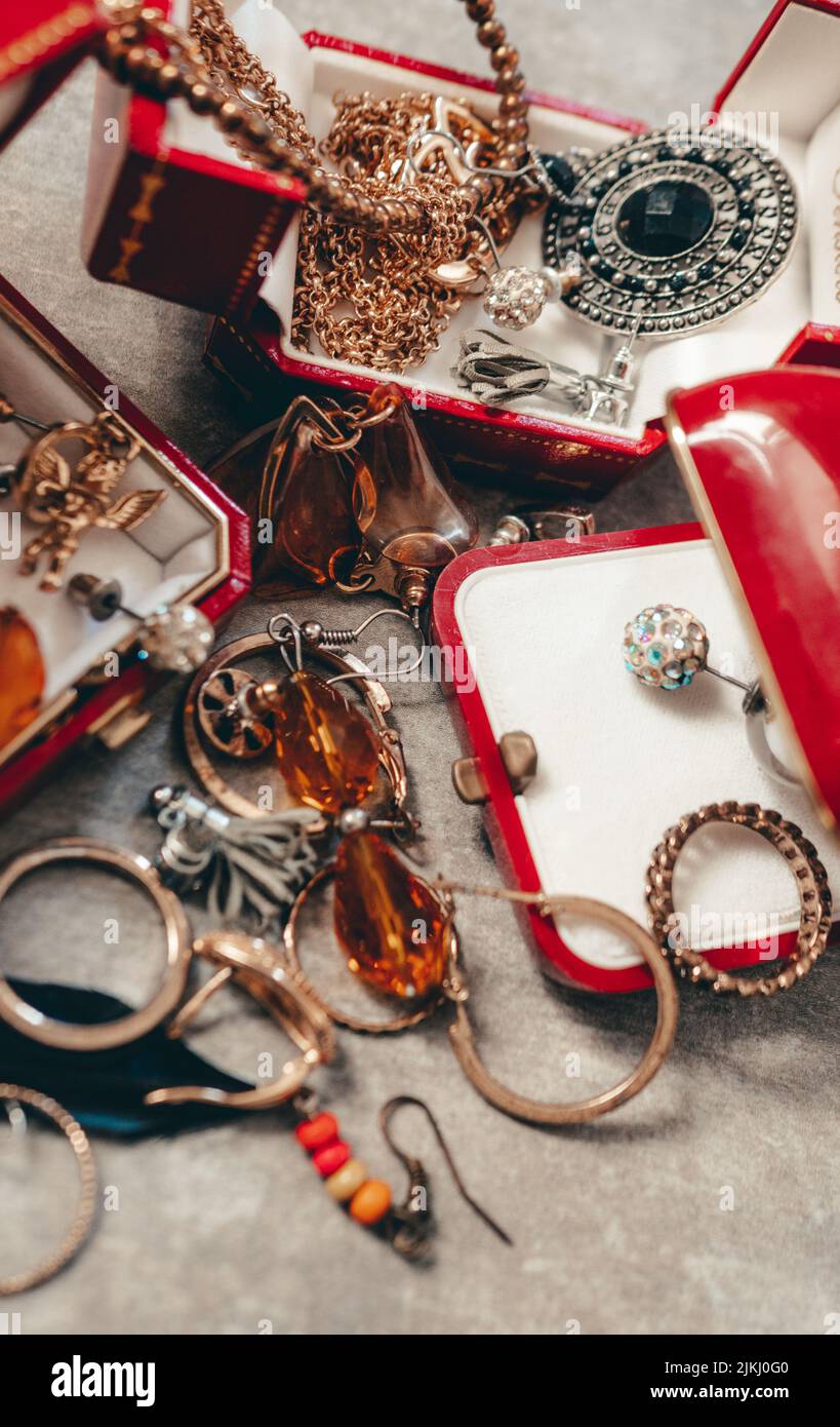 Old red boxes full of jewelry. Treasure chest, close up Stock Photo - Alamy