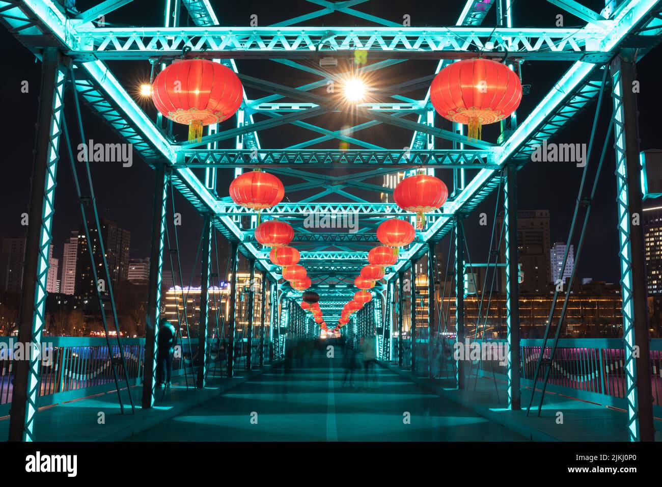 An illuminated bridge in modern Tianjin port city in China at night ...