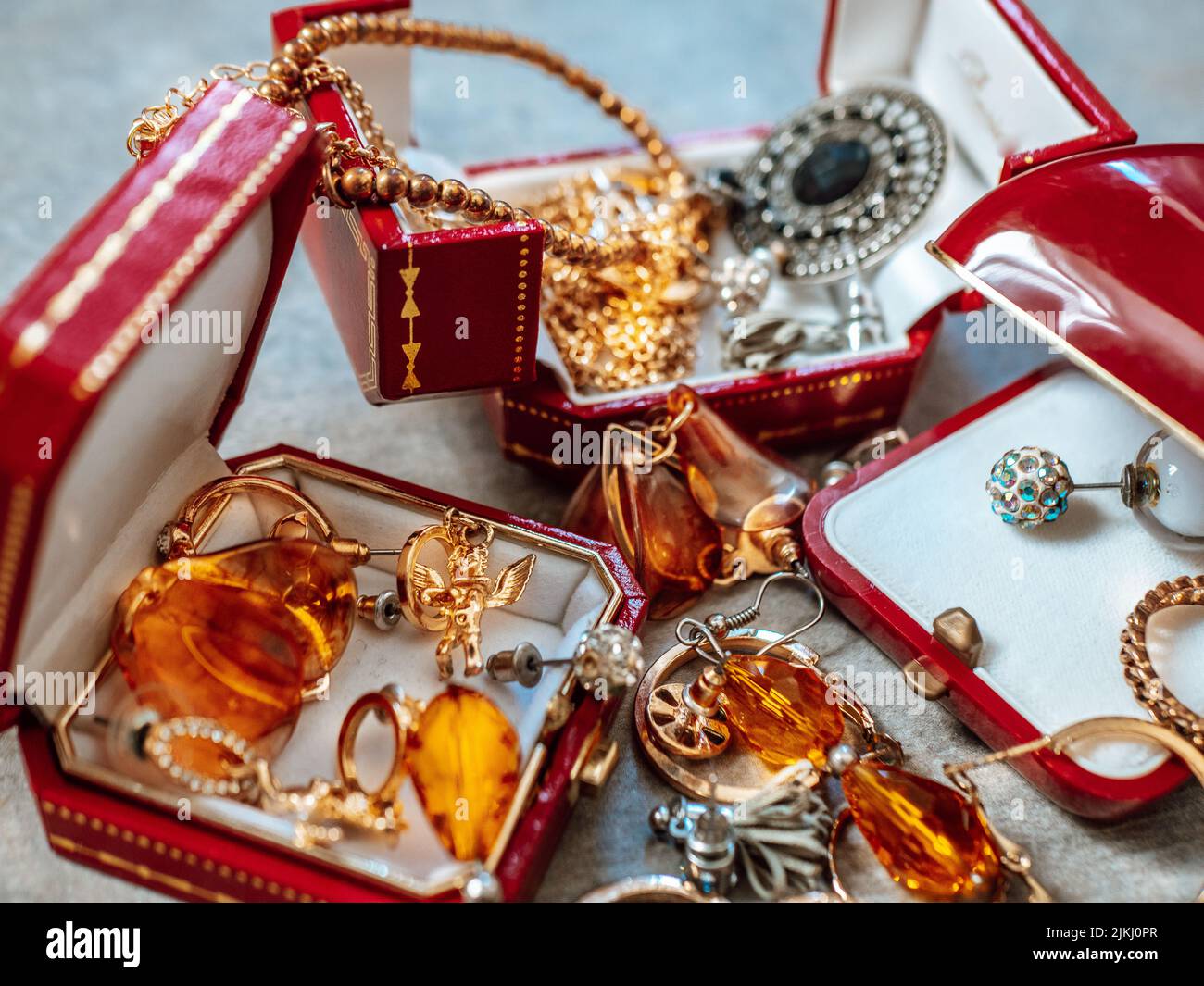 Old red boxes full of jewelry. Treasure chest, close up Stock Photo - Alamy
