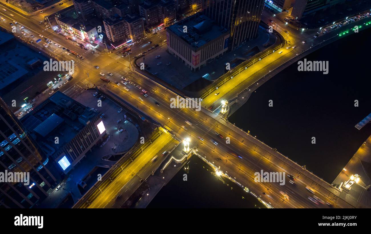 A night view of a traffic road with cars and buildings Stock Photo - Alamy