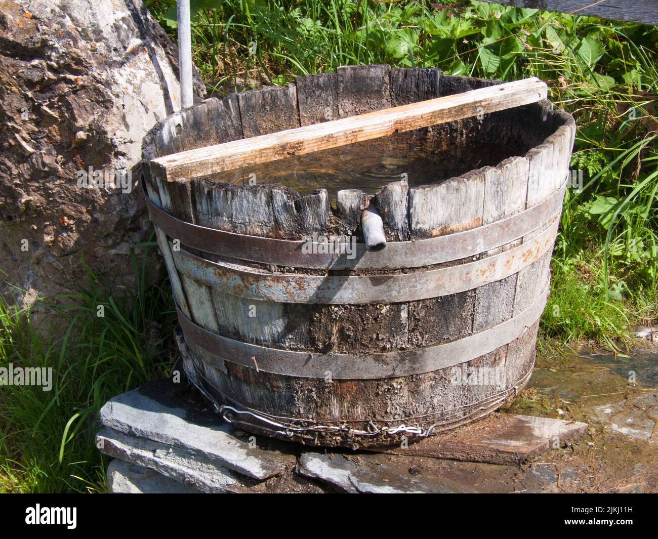 A closeup shot of an old wooden barrel filled with water Stock Photo ...