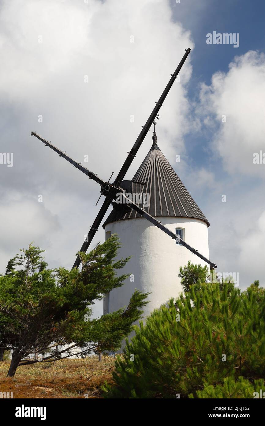 A vertical shot of traditional Dutch windmill under a cloudy sky Stock ...