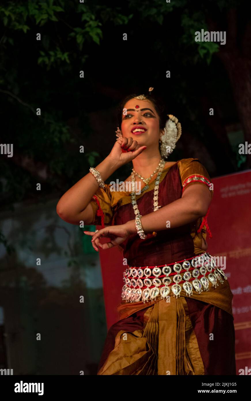 A photo of a young Indian female artist performing Indian classical ...