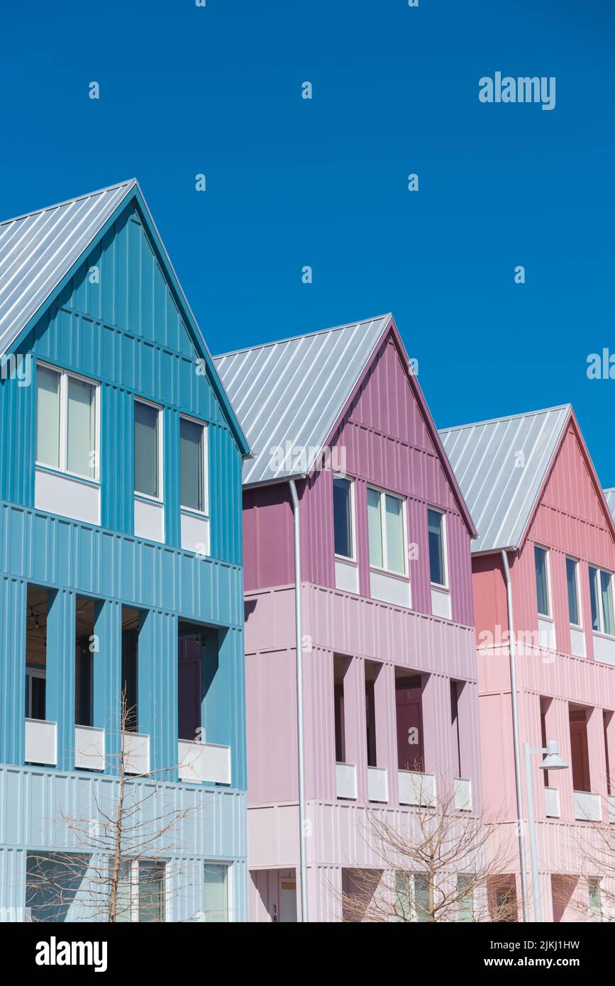 Lookup view of metal roof and gutter on row of new development colorful ...