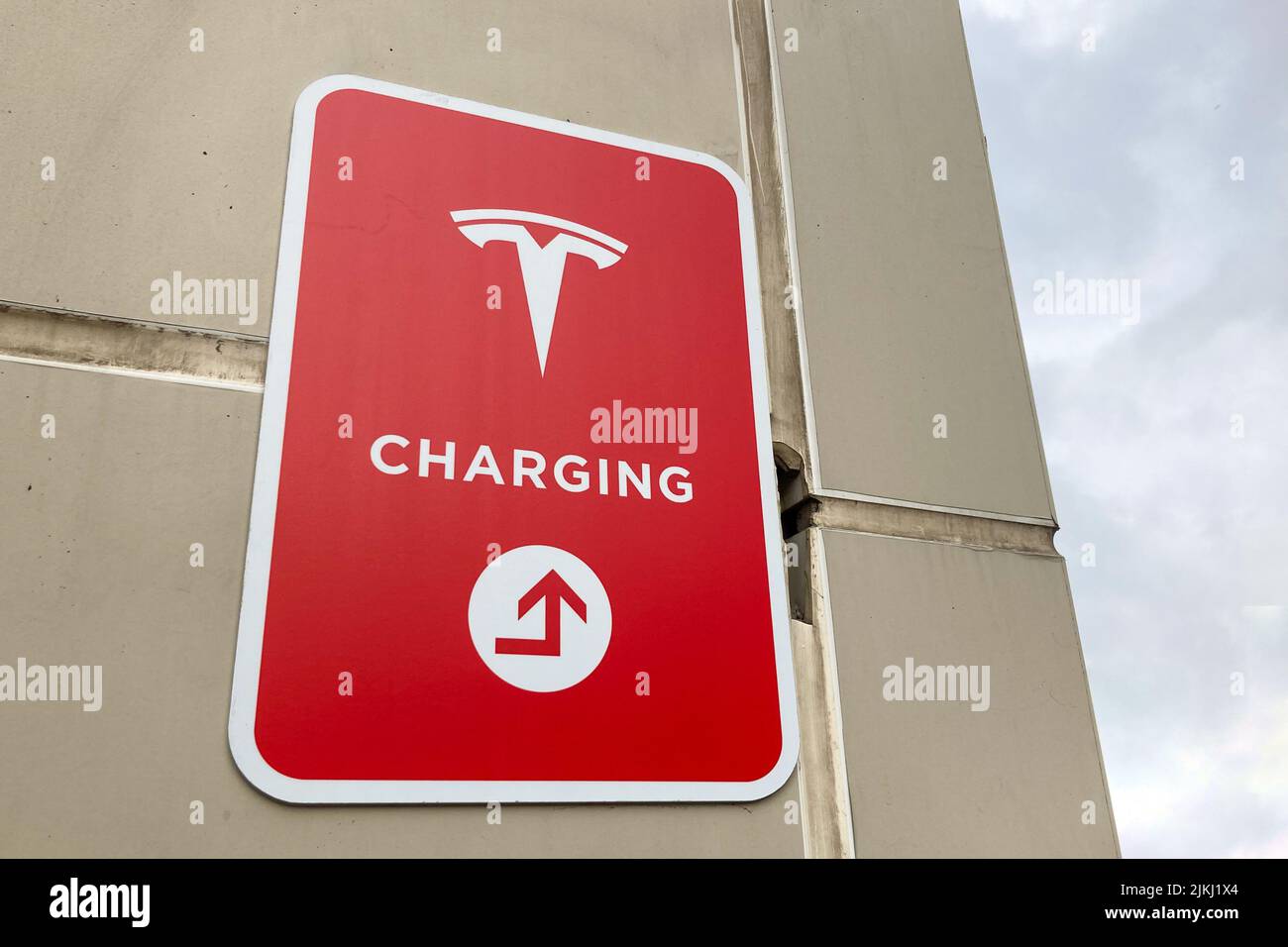 A closeup shot of a Tesla electric car charging station sign in Hong ...
