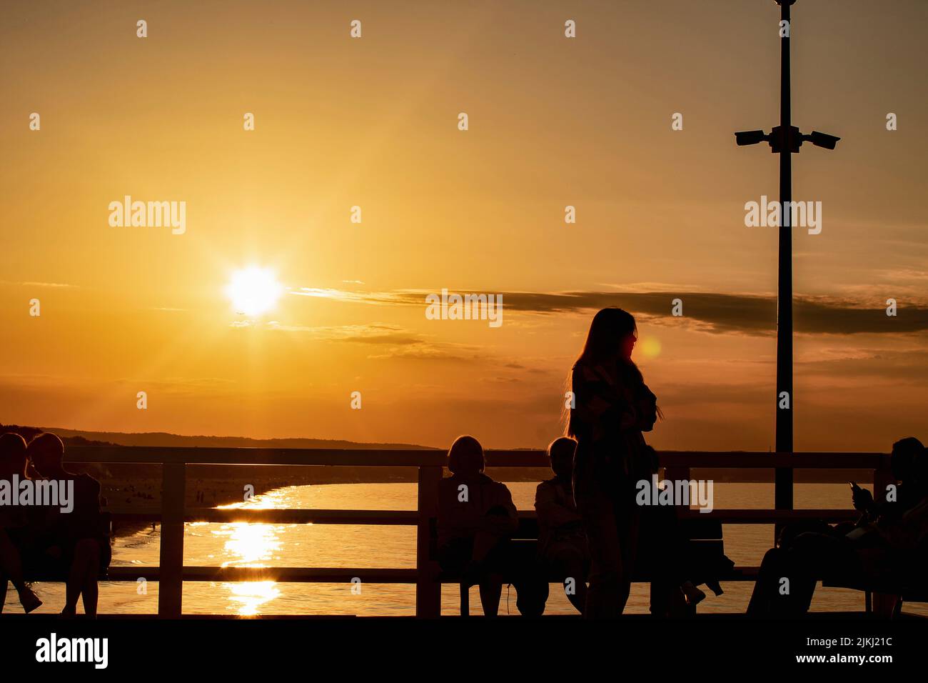 People enjoying the sunset at the sea Stock Photo - Alamy