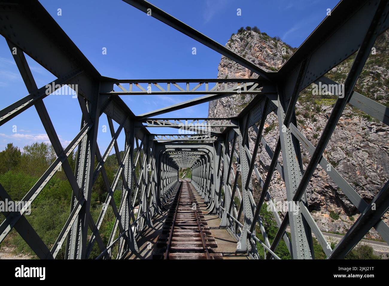 A closeup of an empty metal footbridge across the mountain cliff Stock ...