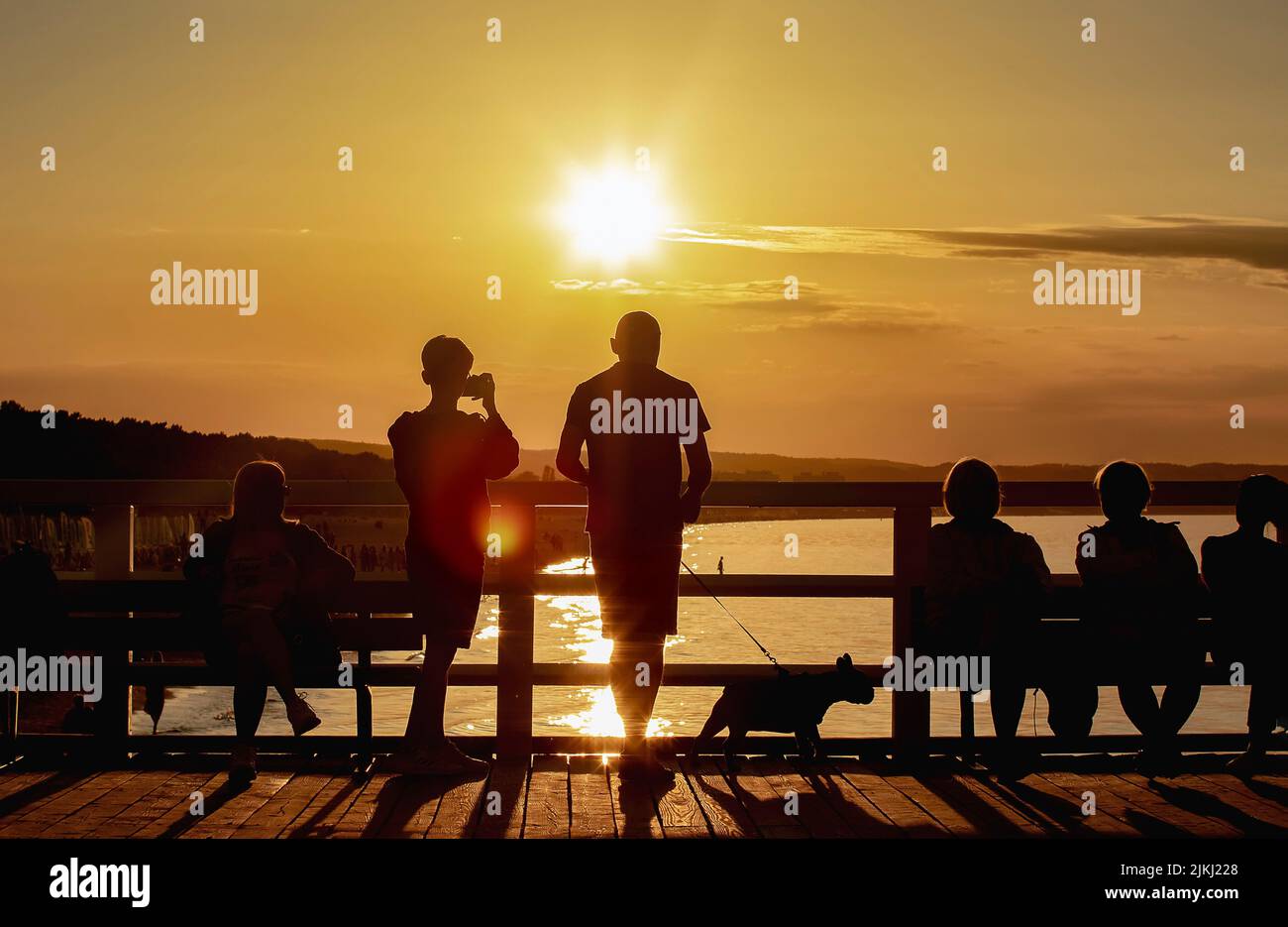 People enjoying the sunset at the sea Stock Photo - Alamy