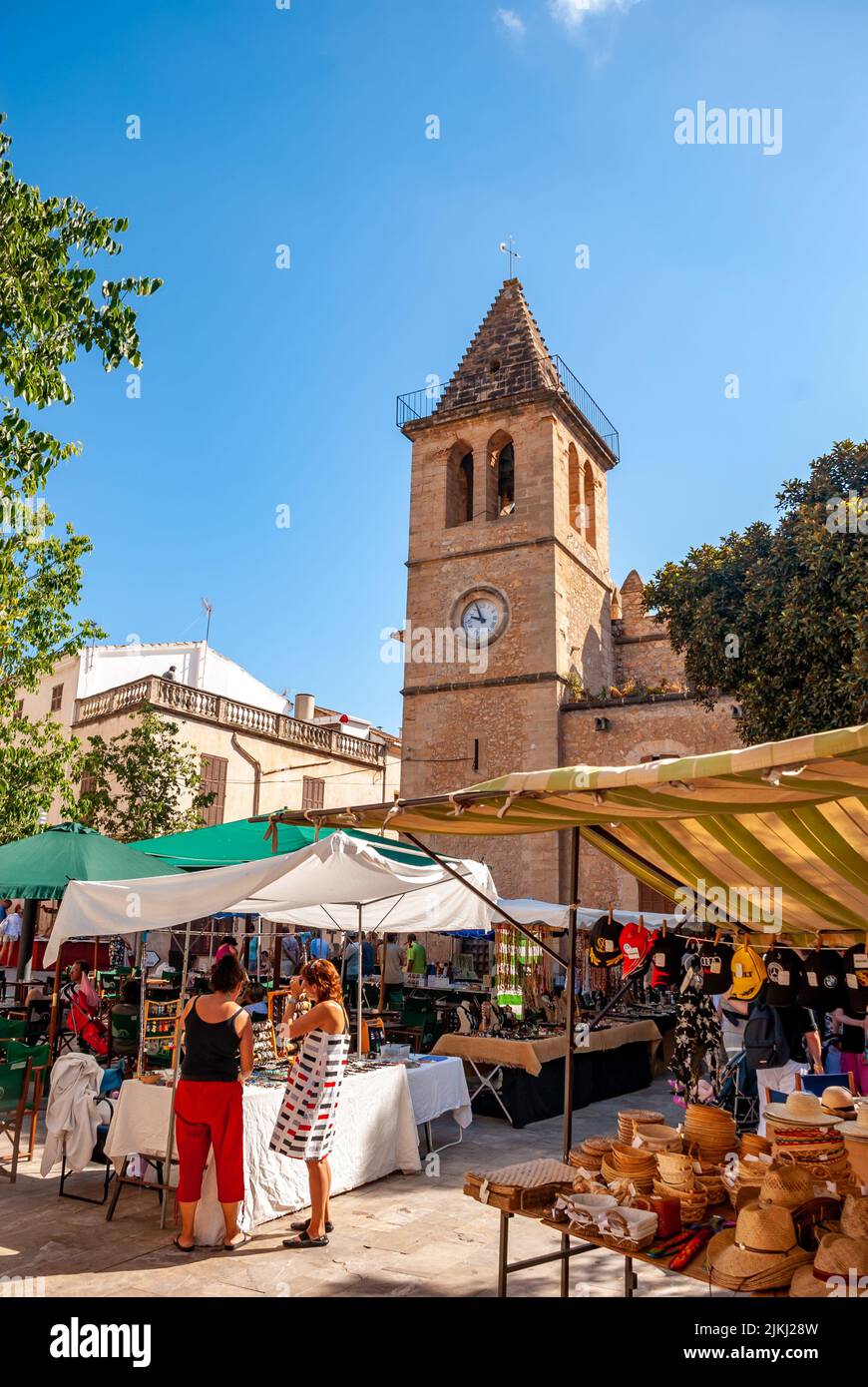 A Market in Son Servera with plenty of market stalls and people ...