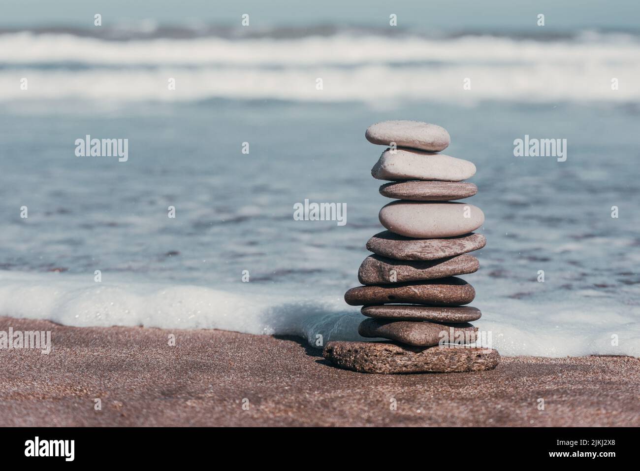 A shallow focus of beach stones stacked on each other on the background ...